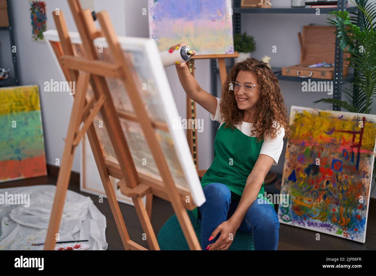 Young beautiful hispanic woman artist smiling confident using graffiti ...