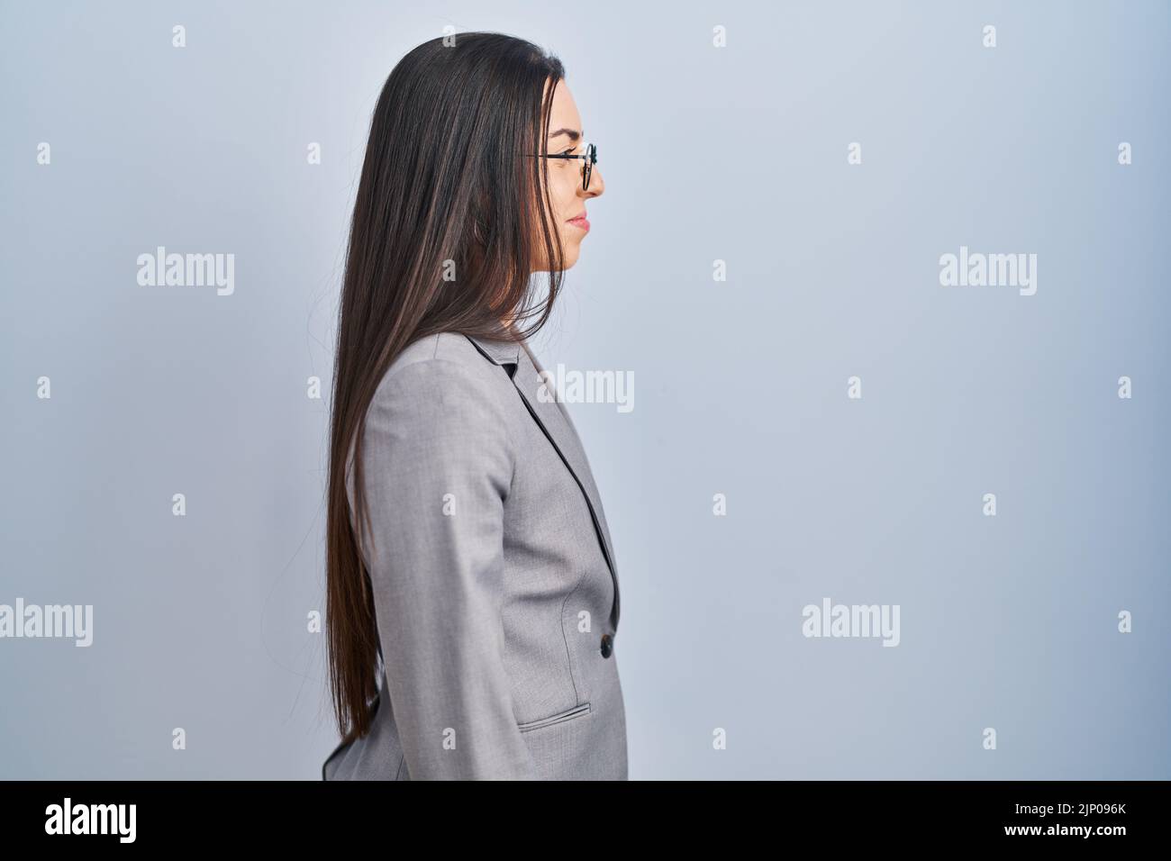 Hispanic business woman wearing glasses looking to side, relax profile ...