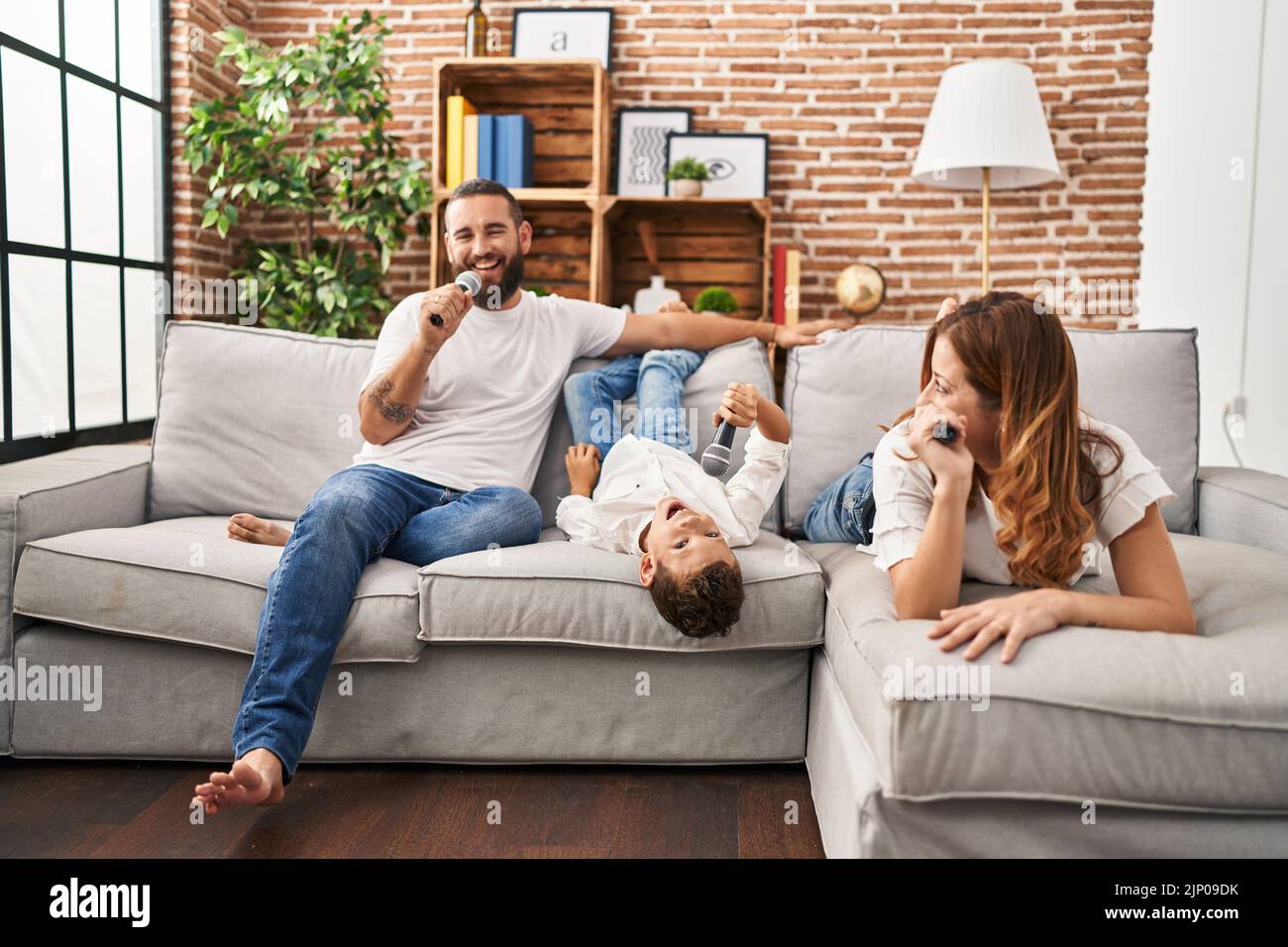 Family singing song using microphone at home Stock Photo - Alamy