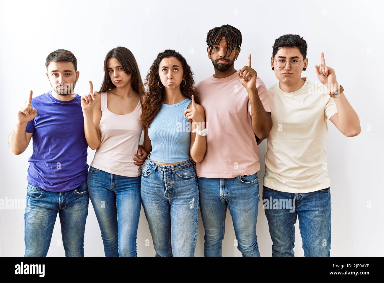 Group of young people standing together over isolated background ...