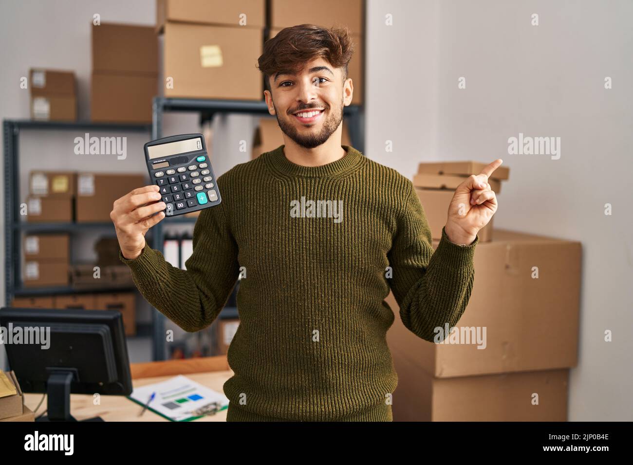 Arab man with beard working at small business ecommerce holding ...