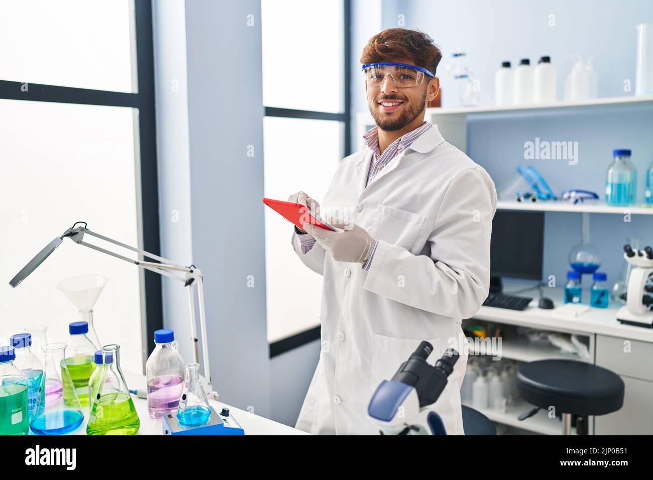 Young arab man scientist using touchpad working at laboratory Stock ...