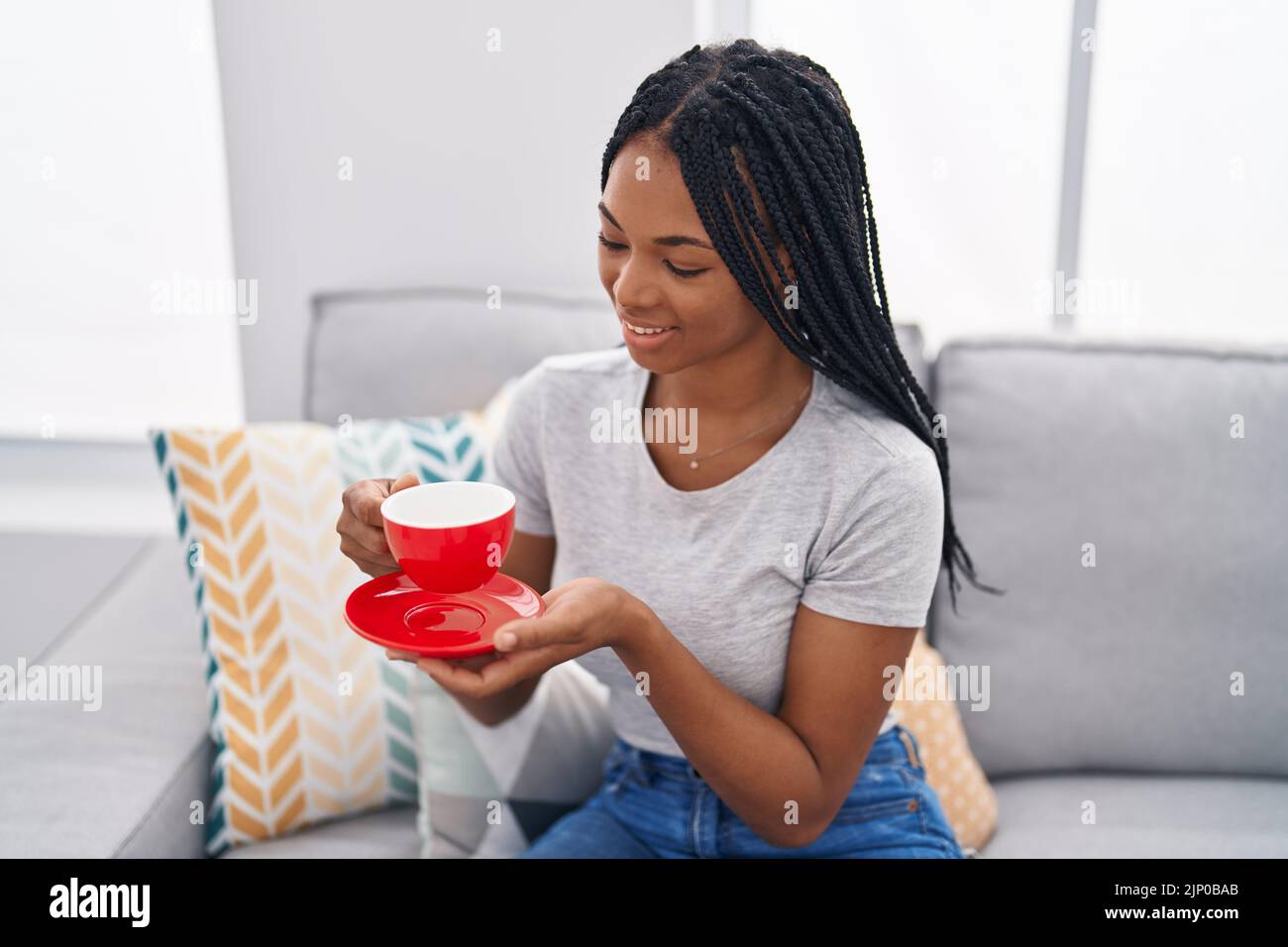 African american woman listening to music drinking coffee at home Stock ...