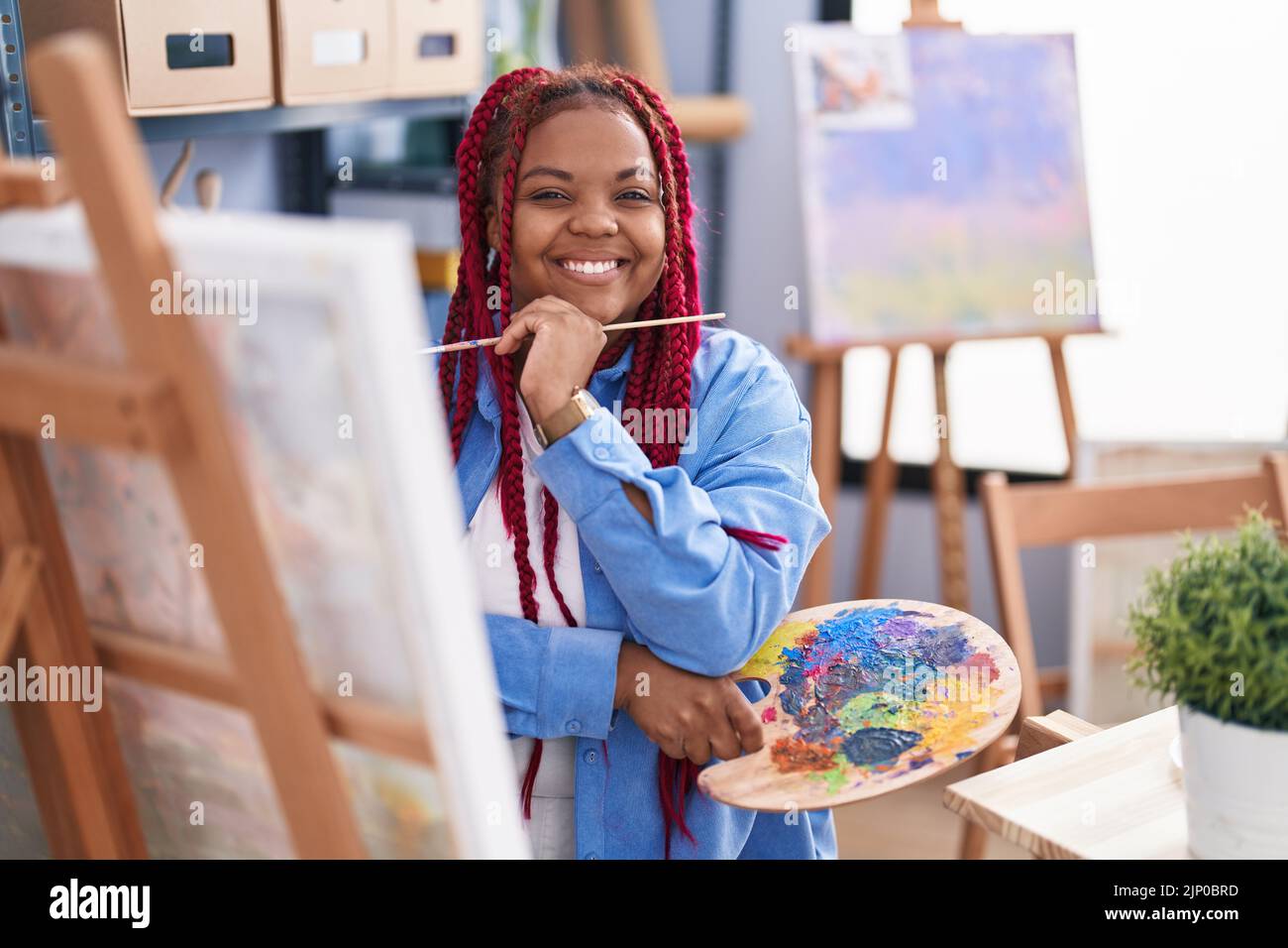 African american woman artist smiling confident drawing at art studio Stock Photo - Alamy