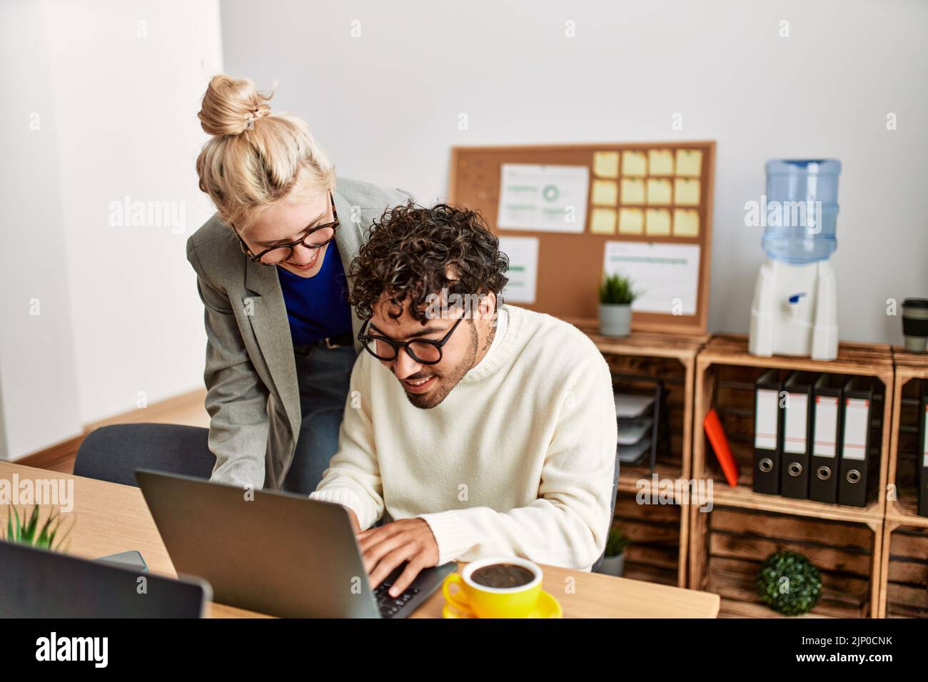 Two hispanic business workers smiling happy working at the office Stock ...