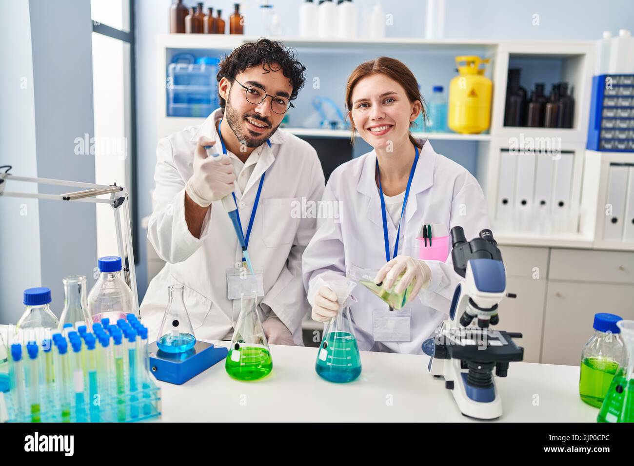 Man and woman scientist partners smiling confident working at ...