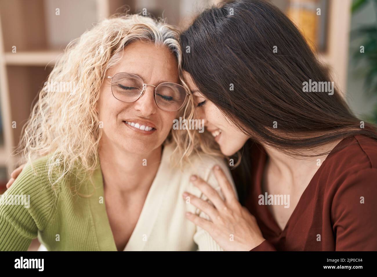 Two women mother and daughter hugging each other at home Stock Photo - Alamy