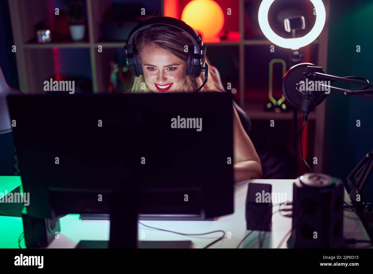 Young beautiful hispanic woman streamer playing video game using ...