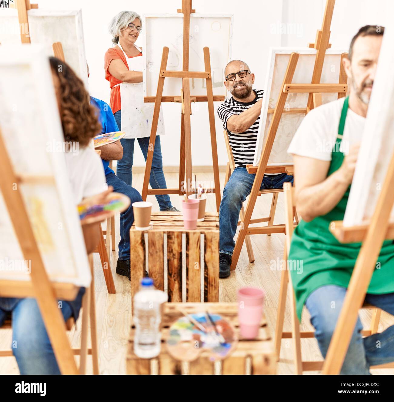 Group of middle age draw students smiling happy drawing at art studio ...
