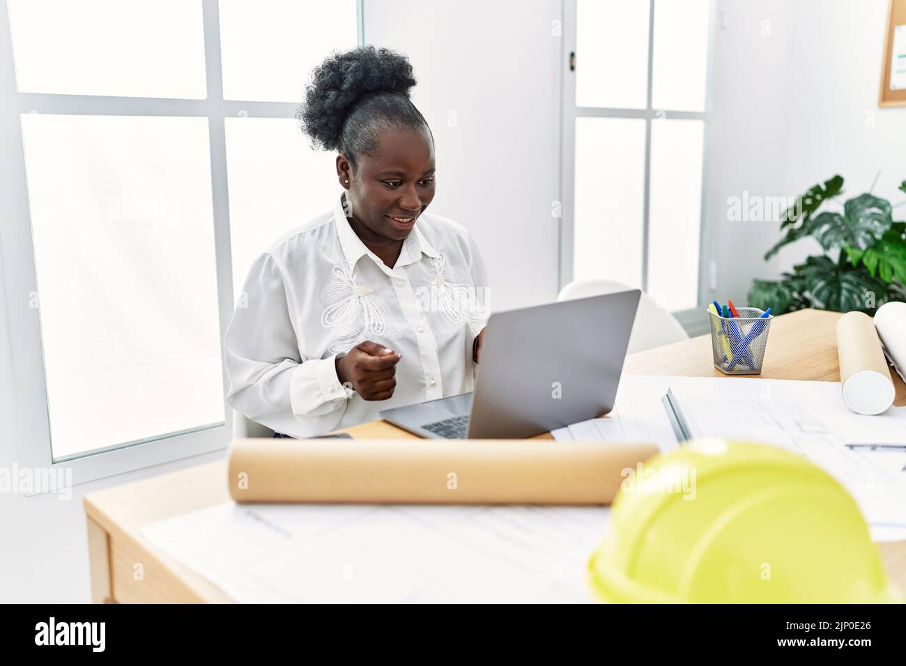 Young african american woman architect having video call at ...