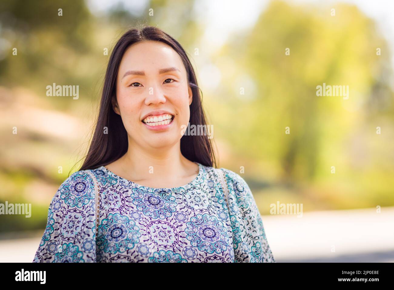 Outdoor portrait of a happy Chinese young adult woman Stock Photo - Alamy