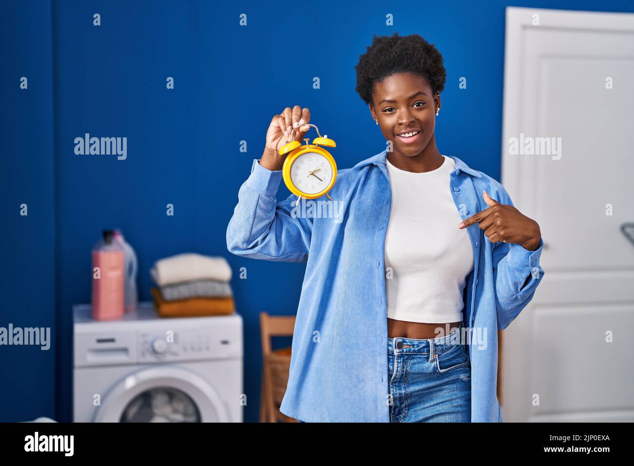African american woman waiting for laundry pointing finger to one self ...