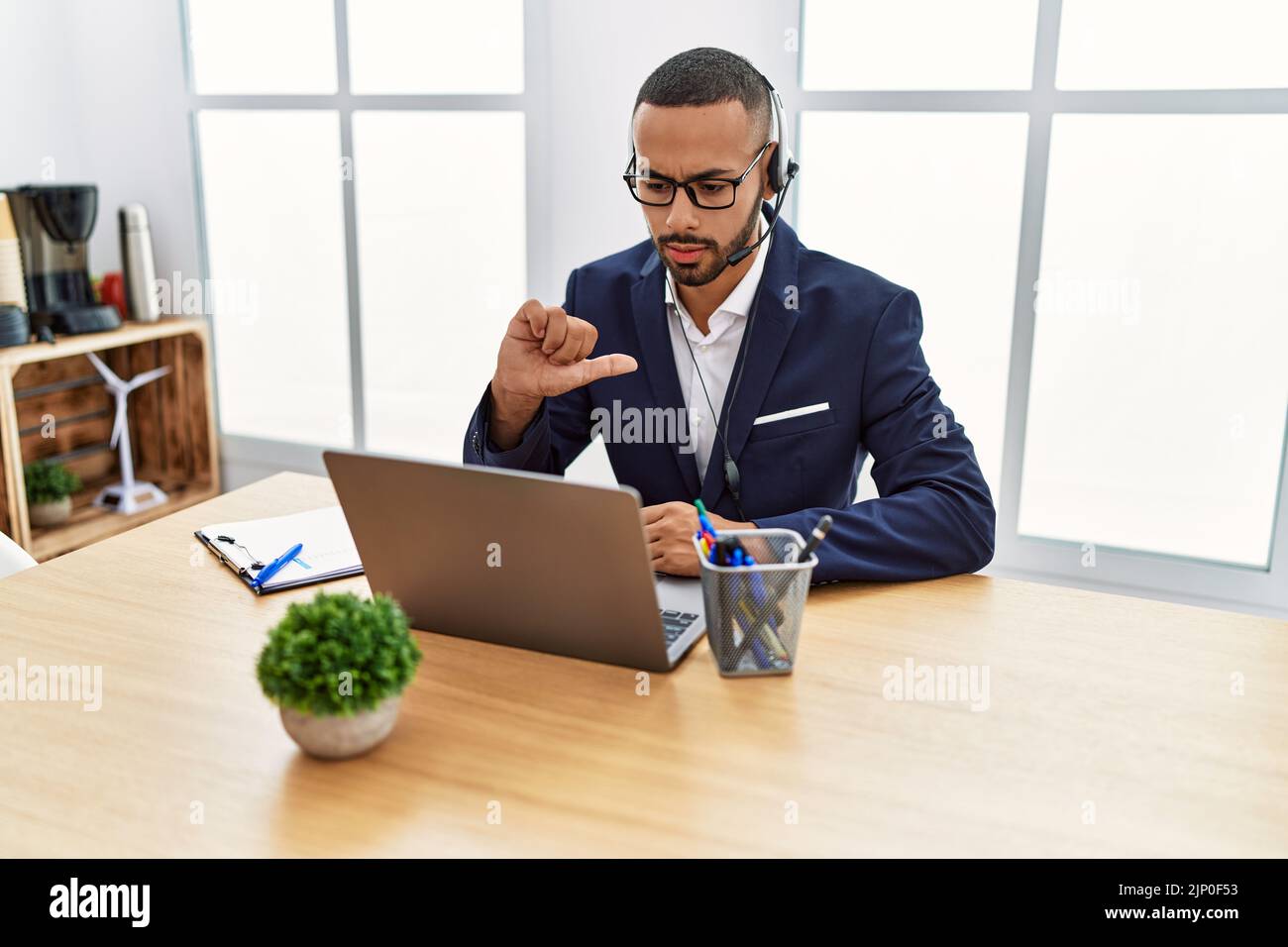 African american young man wearing call center agent headset at the ...