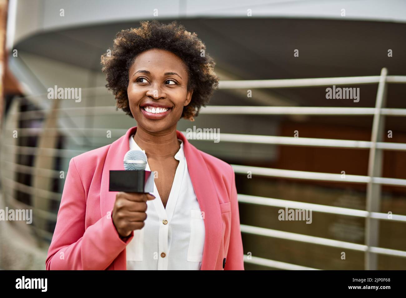 Young african american woman journalist holding reporter microphone ...