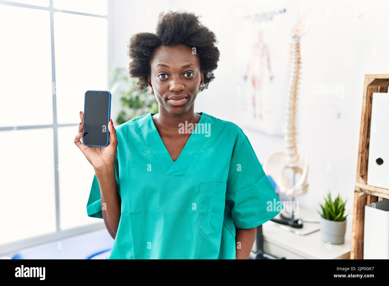 African young physiotherapist woman working at pain recovery clinic ...