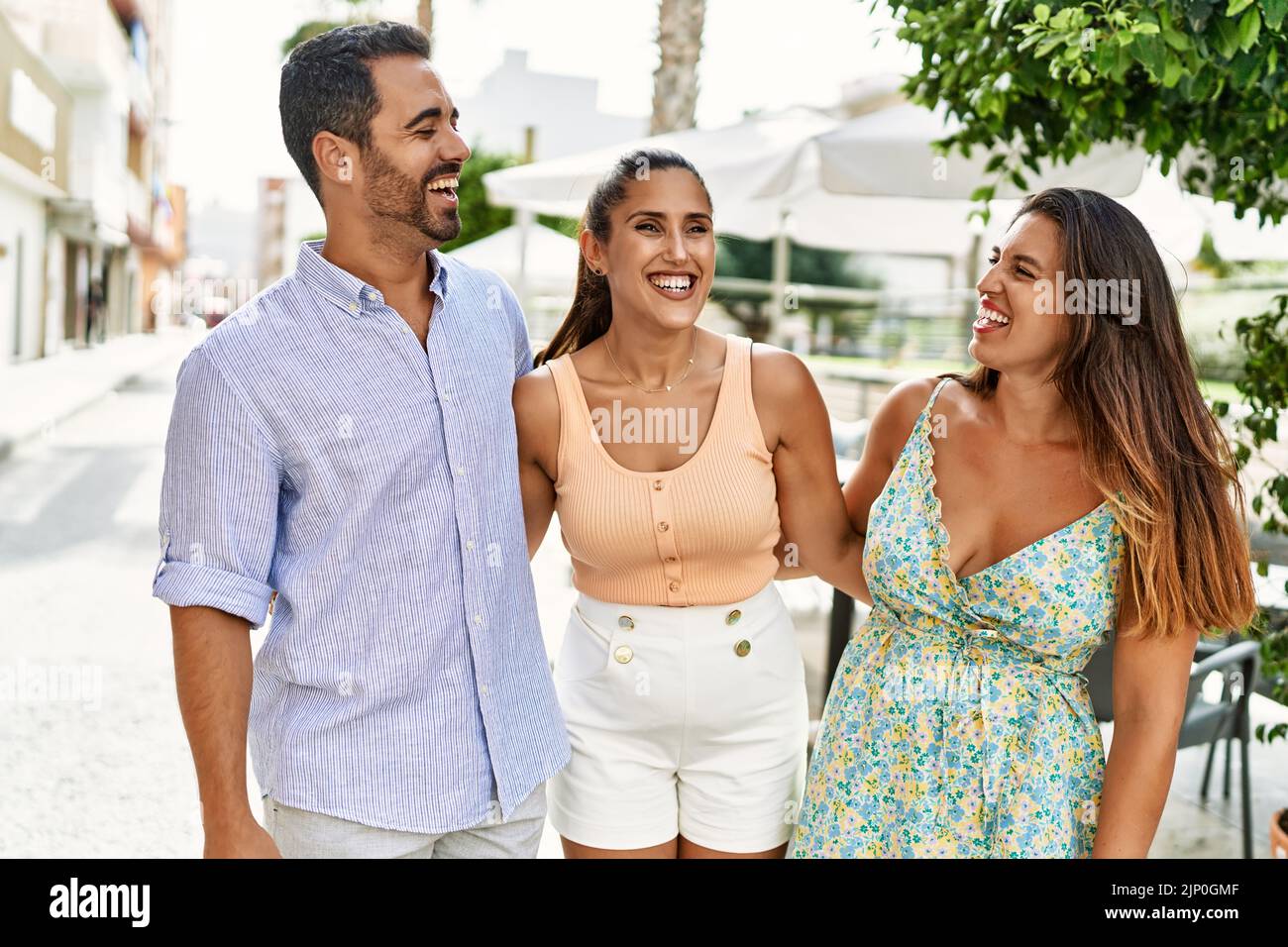 Three hispanic friends smiling happy and hugging at the city Stock ...