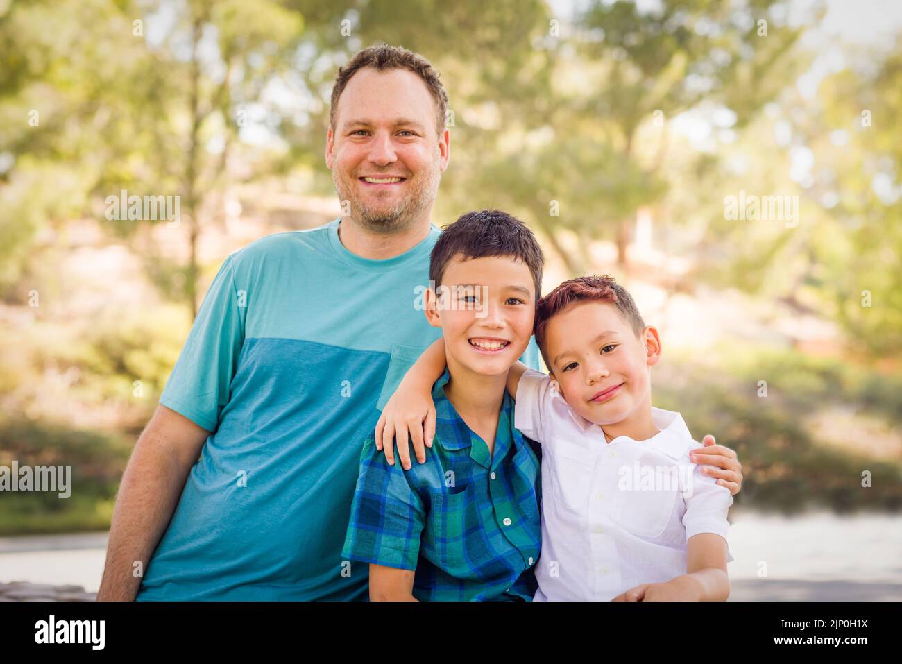 Outdoor portrait of mixed race Chinese and Caucasian brothers and their ...