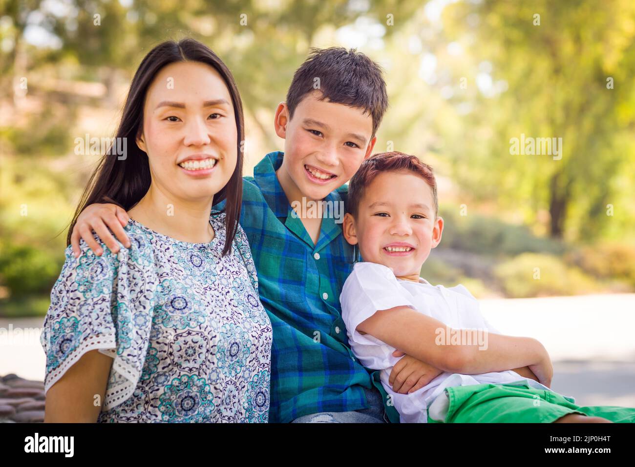 Outdoor portrait of mixed race Chinese and Caucasian brothers and their ...