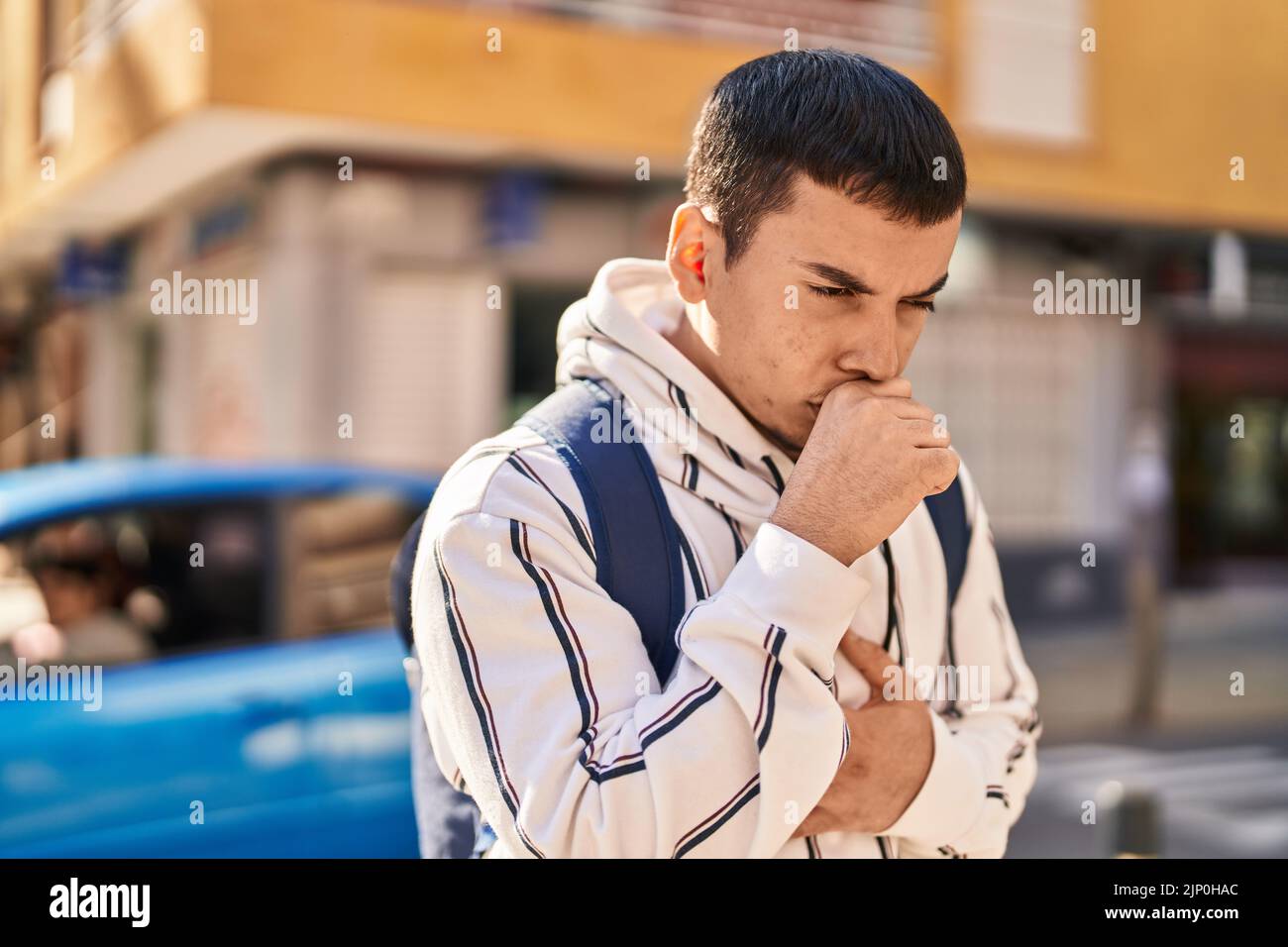 Young man student coughing at street Stock Photo - Alamy