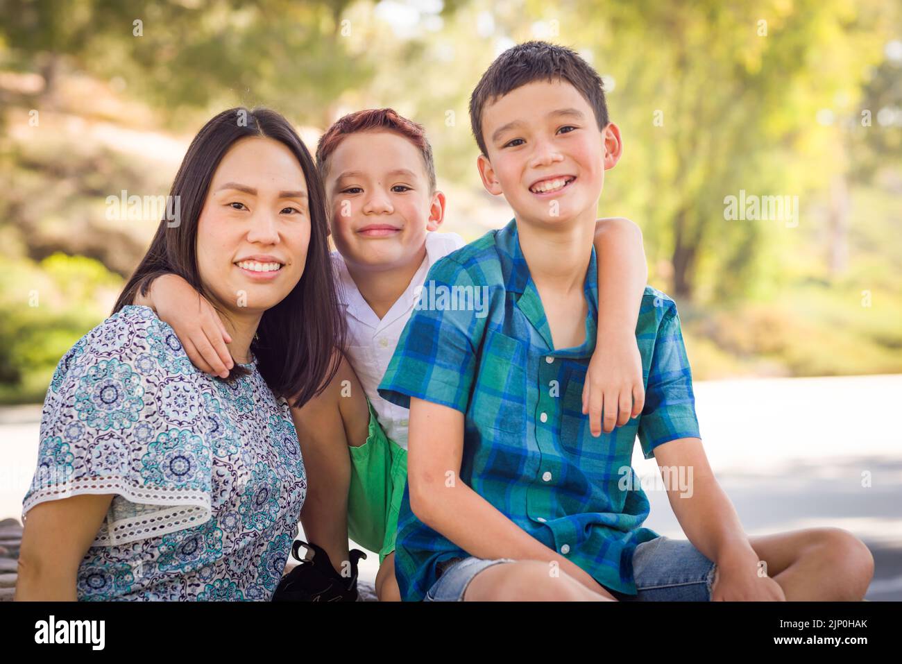Outdoor portrait of mixed race Chinese and Caucasian brothers and their ...