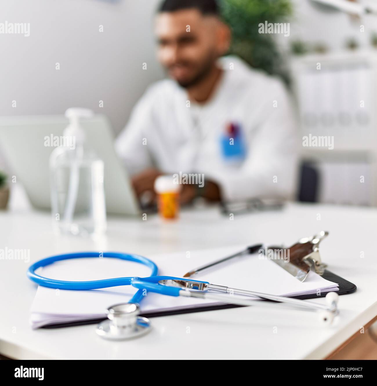 Young arab man wearing doctor uniform working at clinic Stock Photo - Alamy