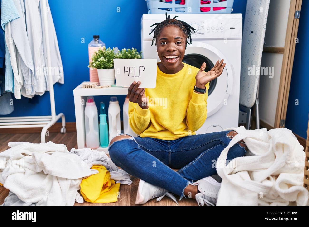 Beautiful black woman doing laundry asking for help celebrating victory ...