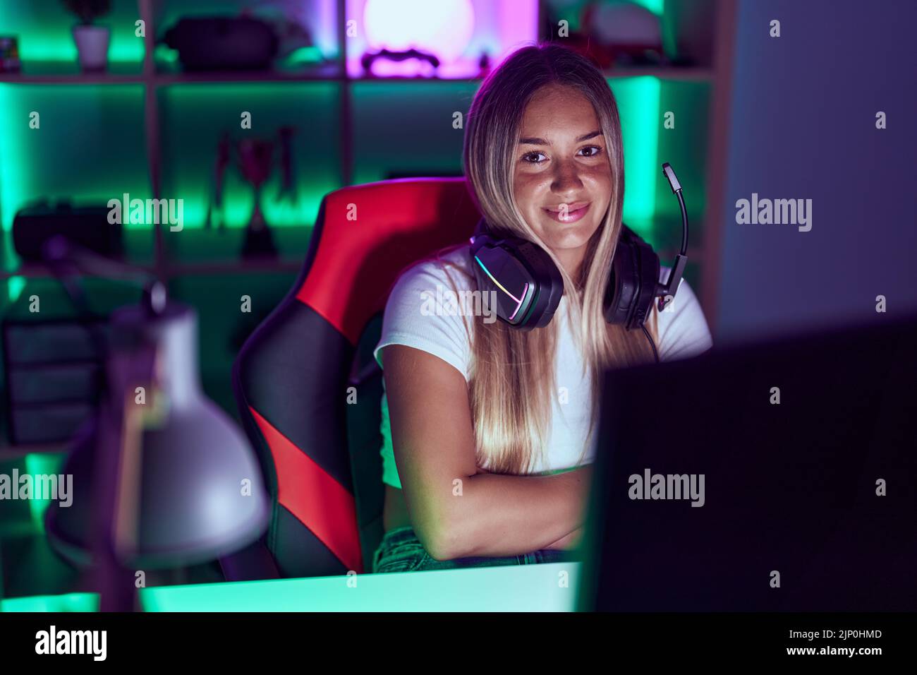 Young beautiful hispanic woman streamer sitting with arms crossed ...