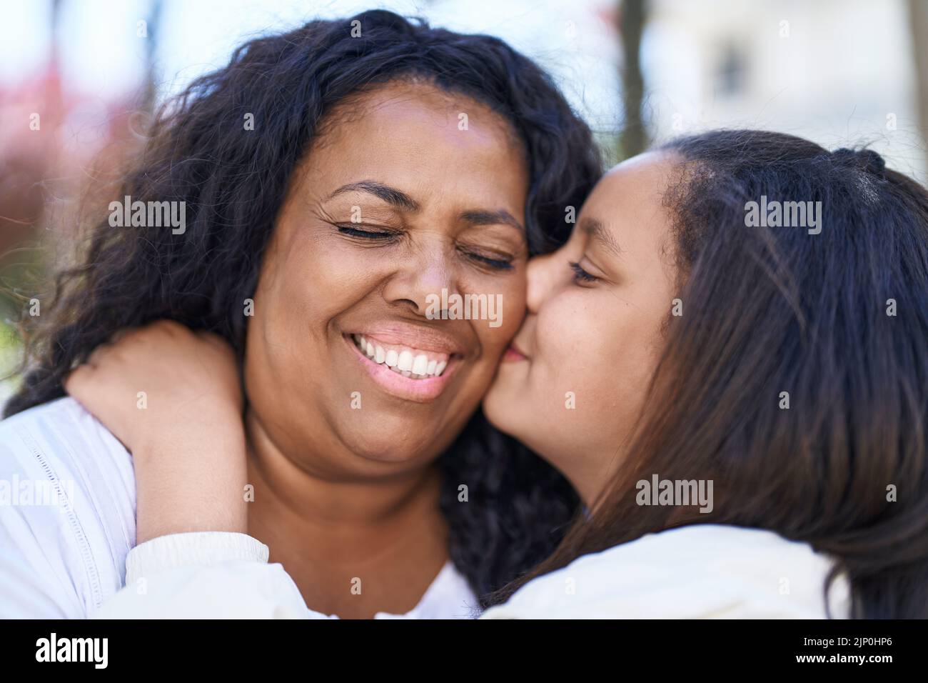 Mother And Daughter Smiling Confident Hugging Each Other And Kissing At