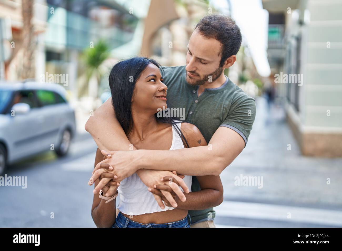Man And Woman Interracial Couple Hugging Each Other At Street Stock