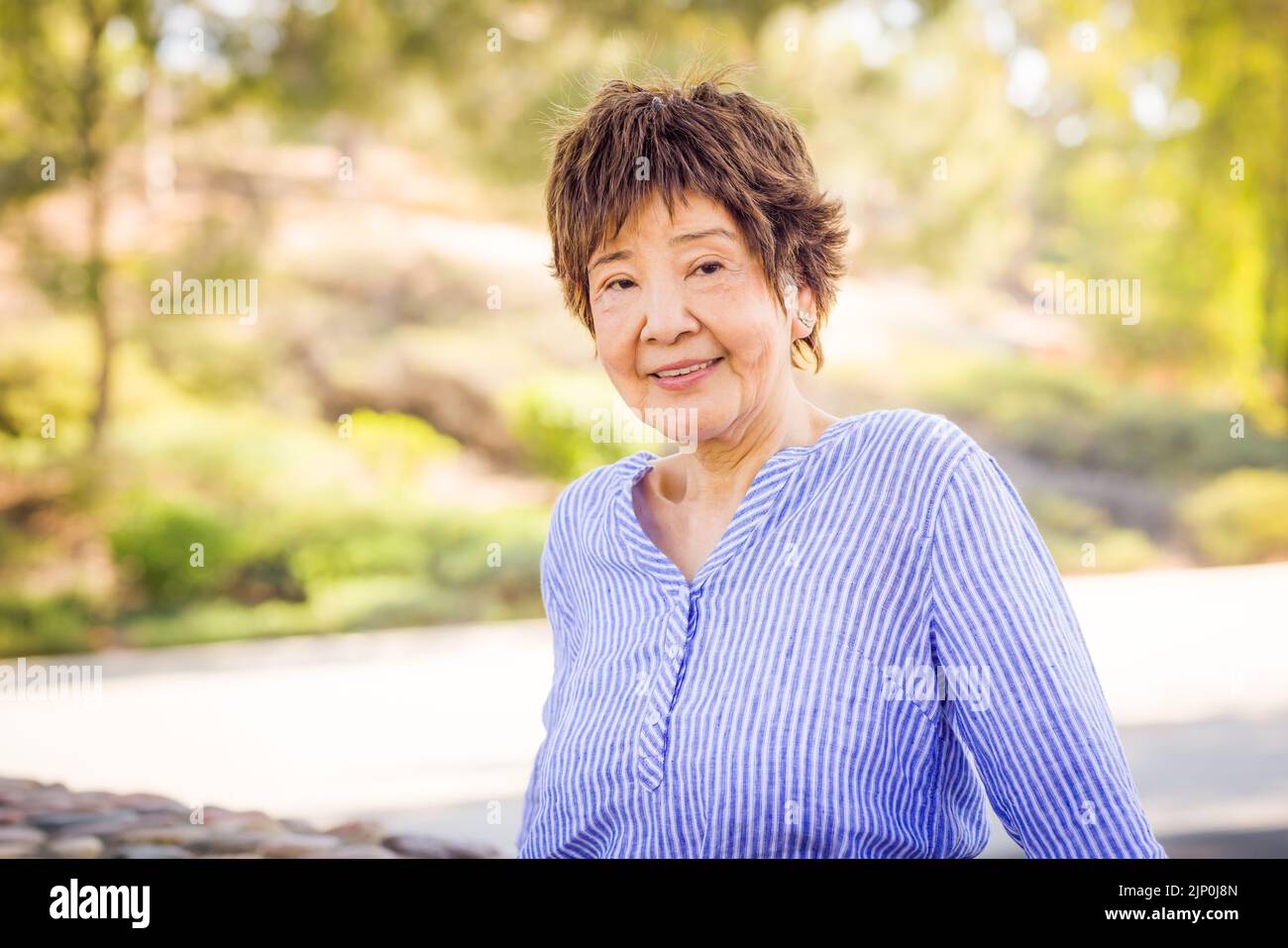 Outdoor portrait of a happy senior adult Chinese woman Stock Photo - Alamy