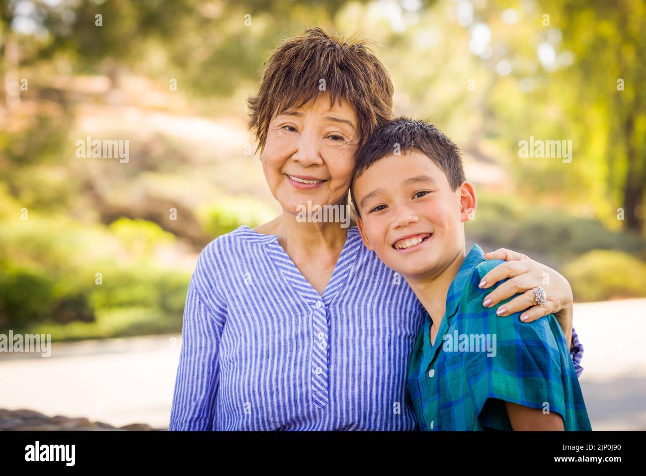 Outdoor portrait of a mixed race Chinese and Caucasian boy and his ...