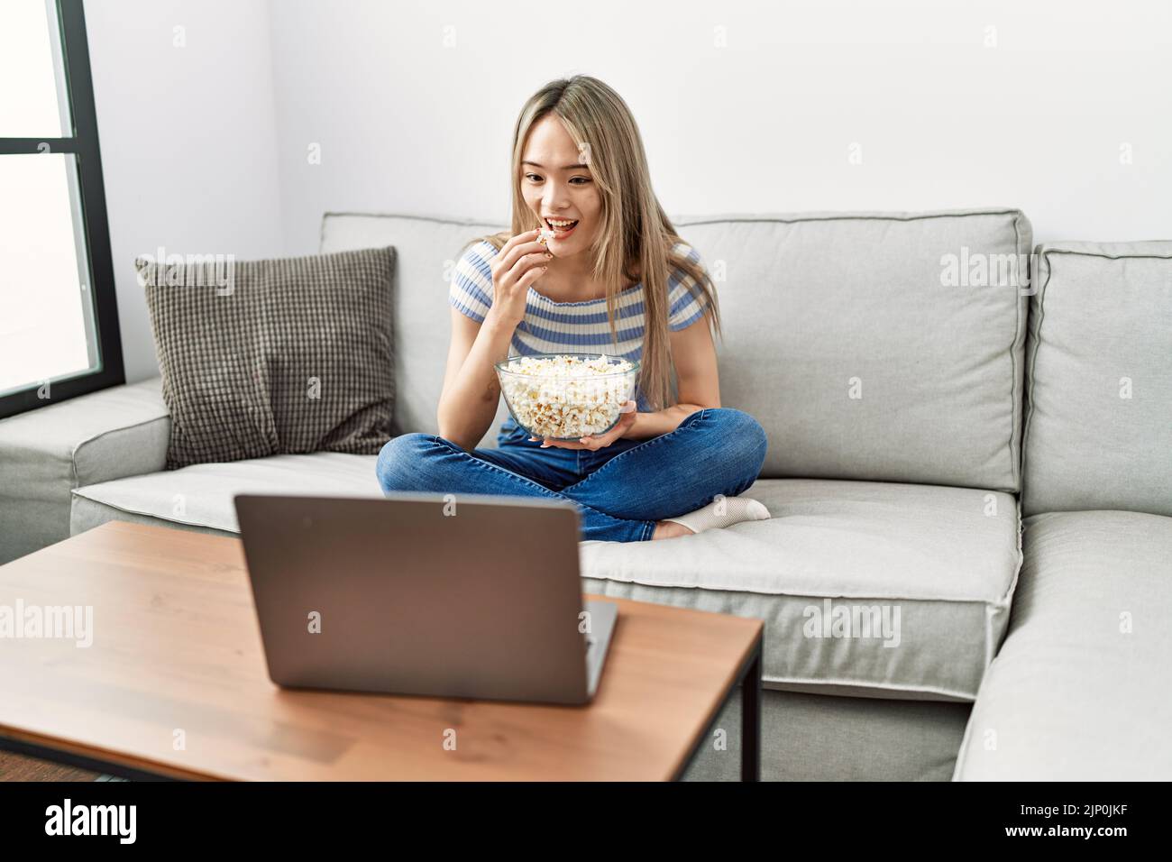 Young chinese woman smiling confident watching movie at home Stock ...