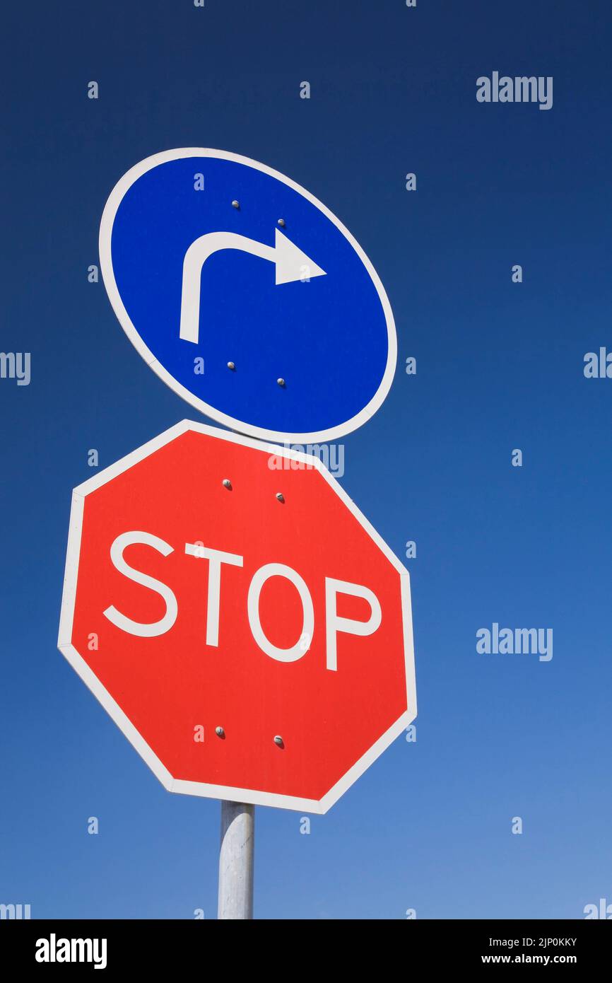 Stop and turn right arrow signs on a steel post, Algarve region ...