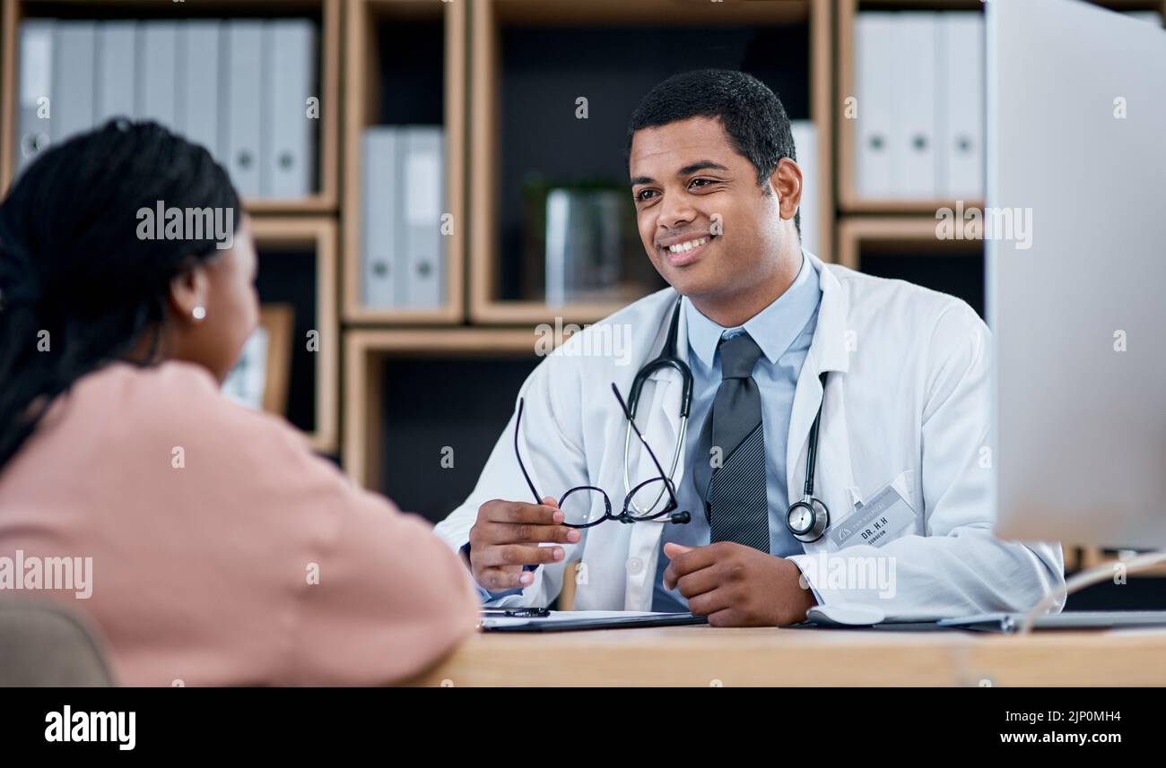 Doctor talking to patient about medical diagnosis or healthcare at an ...