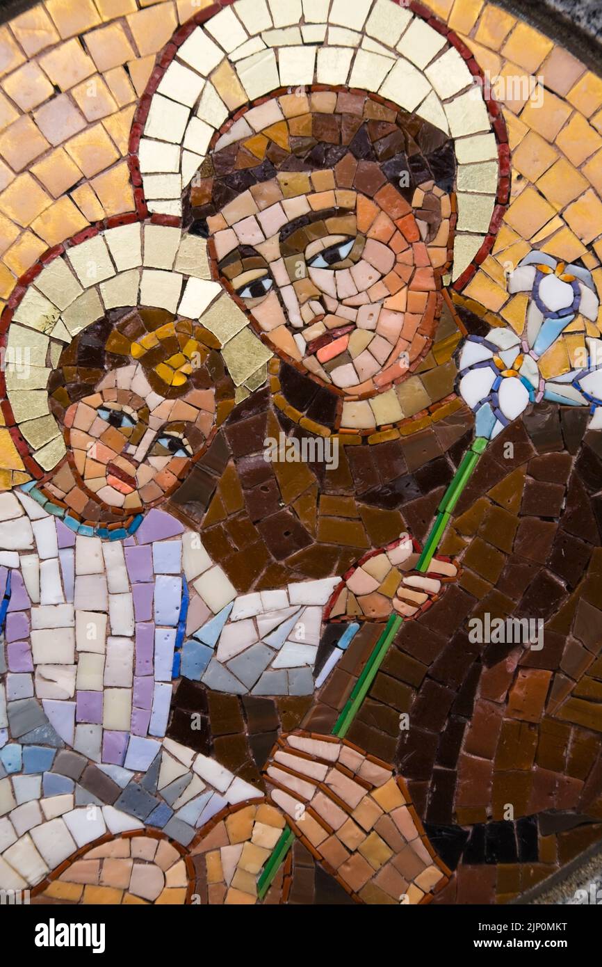 Mosaic made up of small ceramic tiles representing a monk holding a ...