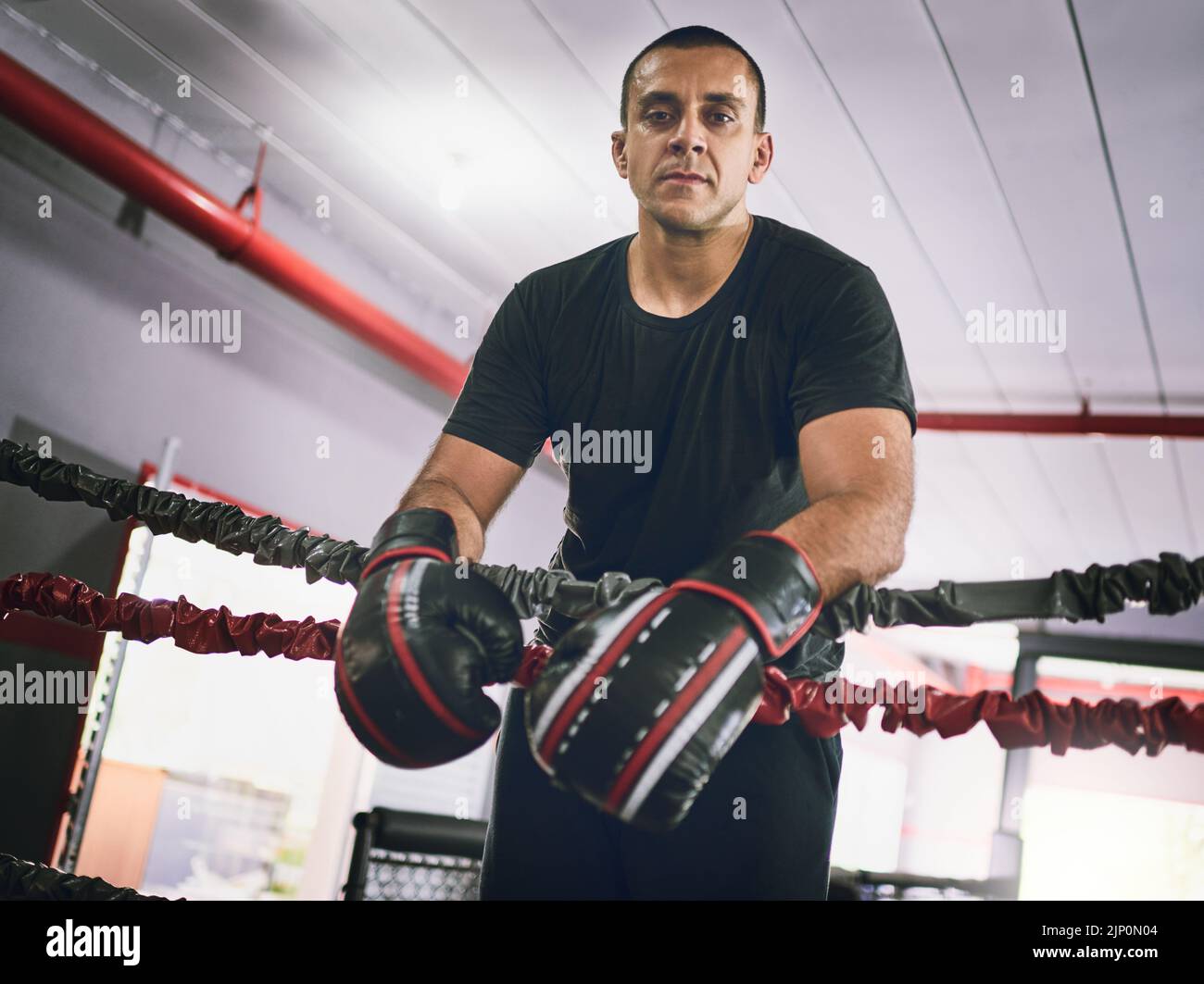 He is waiting to for a fight. Portrait of a confident young male boxer ...