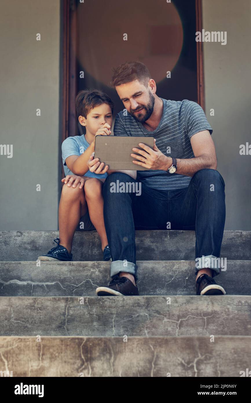 Theres a lot to learn from Dad. a father and son using a digital tablet ...