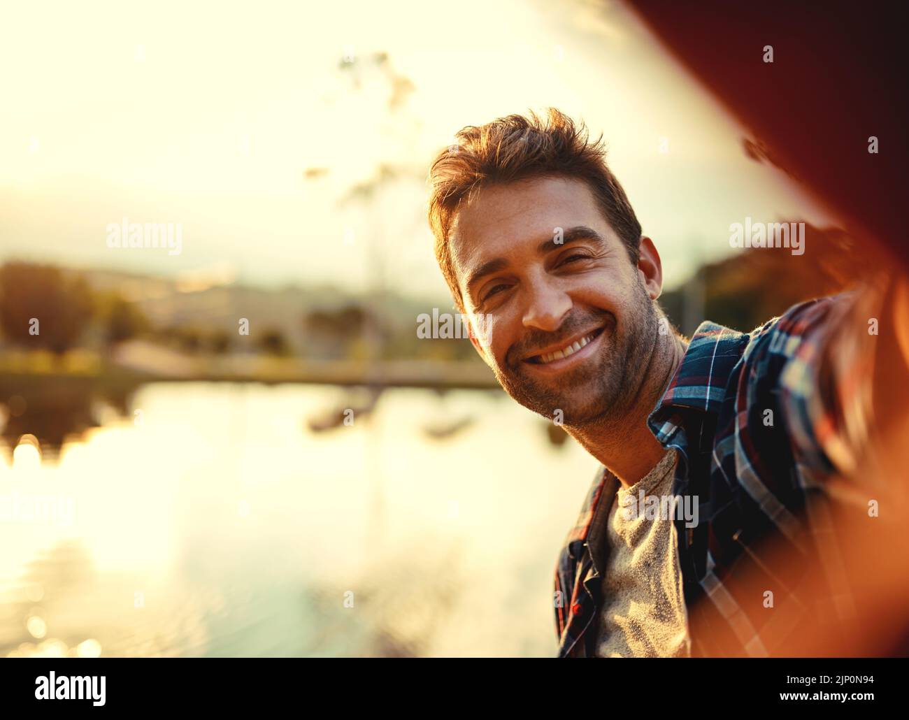 Its awesome out here. Cropped portrait of a handsome young man taking ...