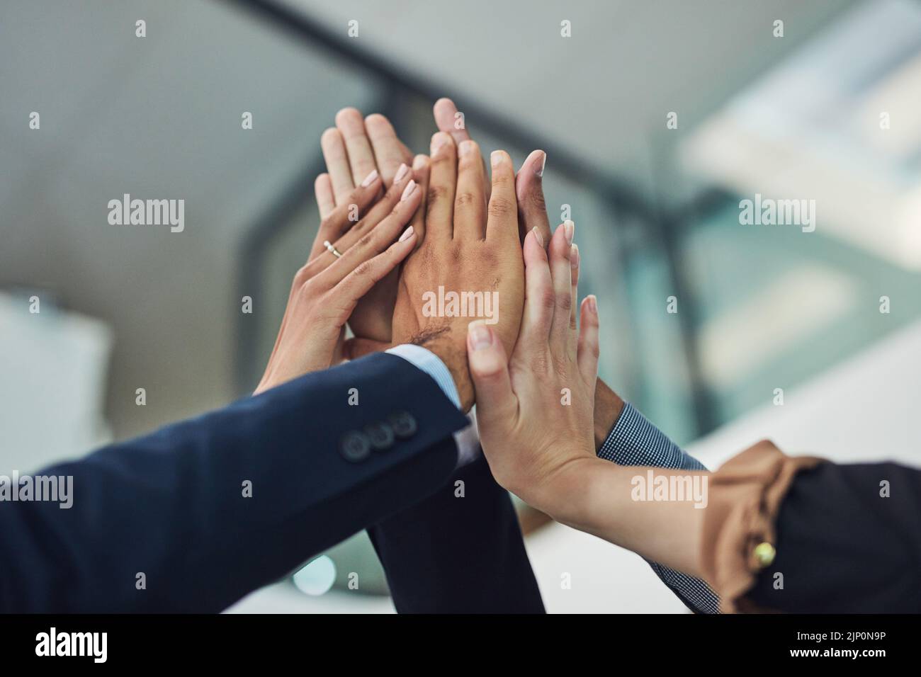 Put them up high for success. Closeup of a group of unrecognizable ...