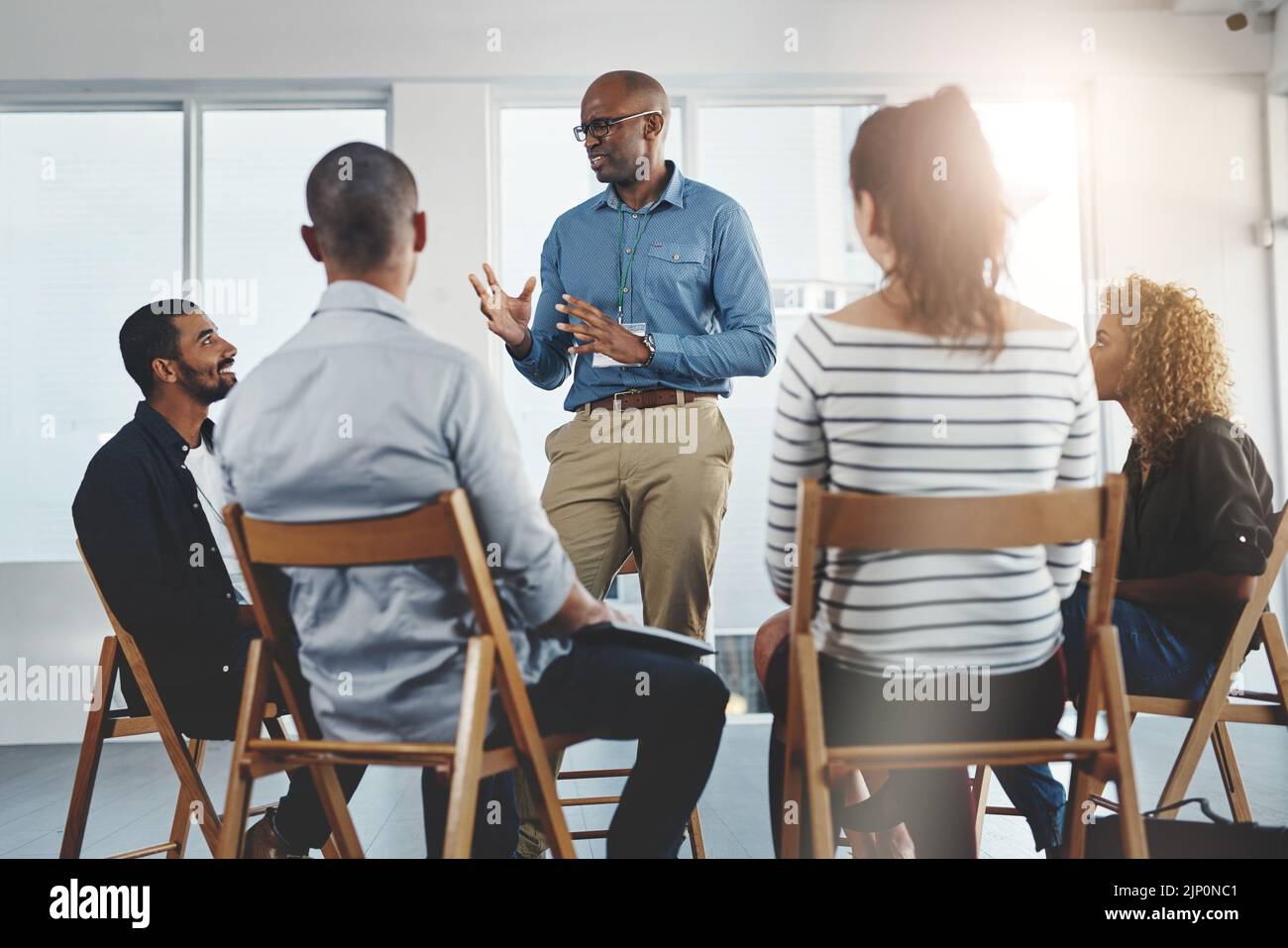 Leader, manager or boss talking to and teaching his team of employees ...