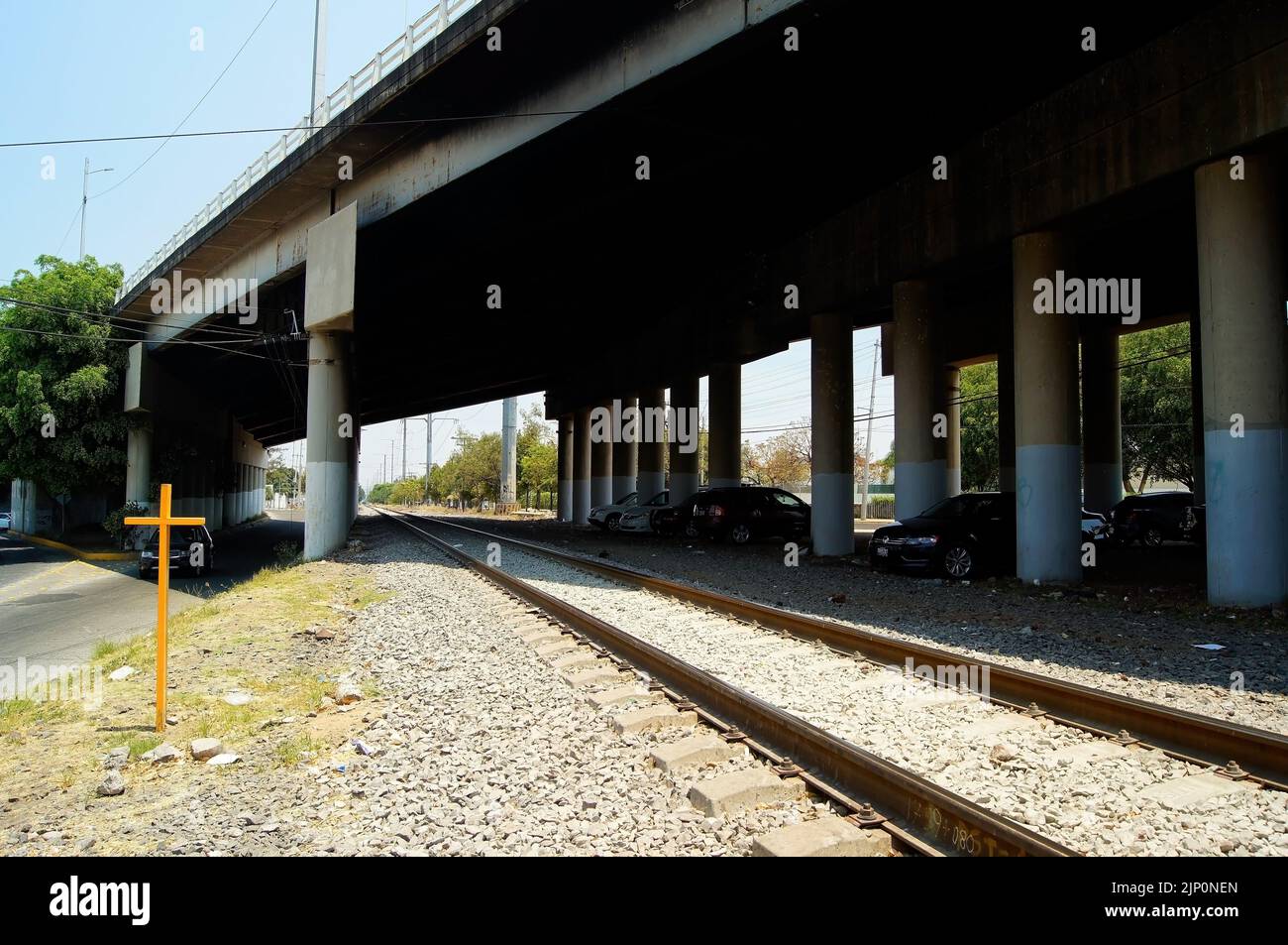view of the lower part of a bridge for cars, showing the railroad ...