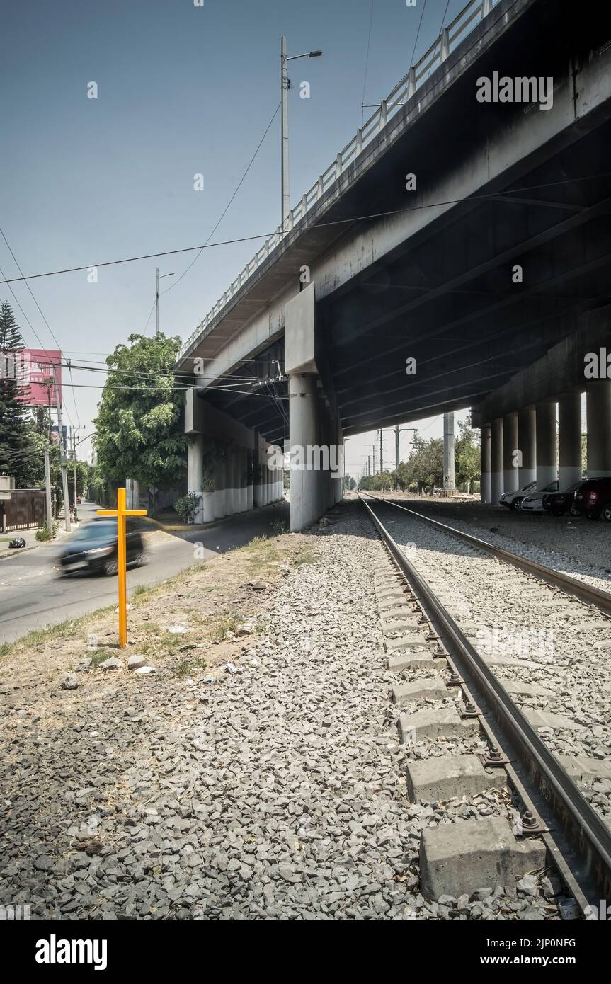 view of the lower part of a bridge for cars, showing the railroad ...