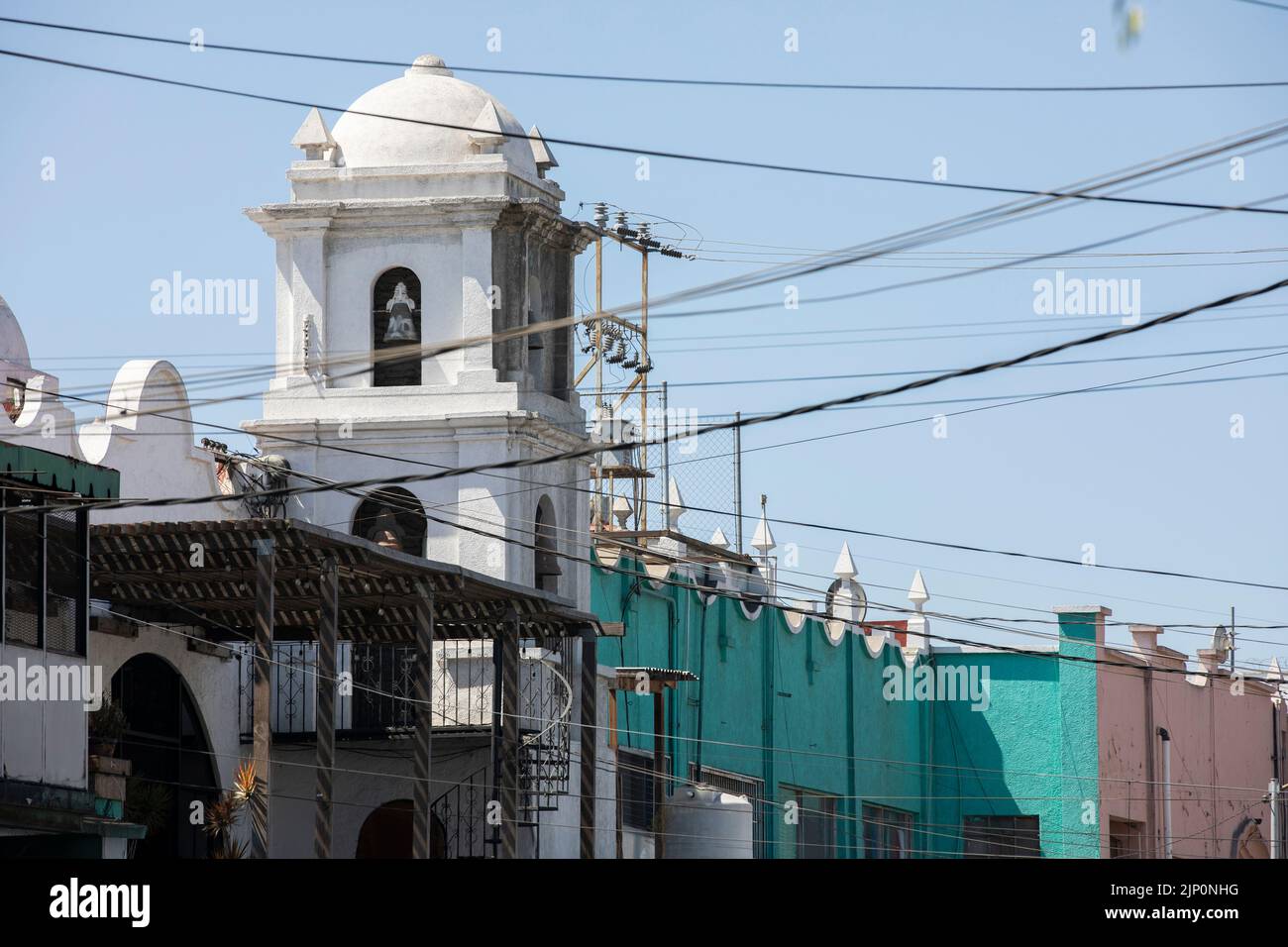 Wires cross the skies in front of a church in downtown Tijuana, Baja ...