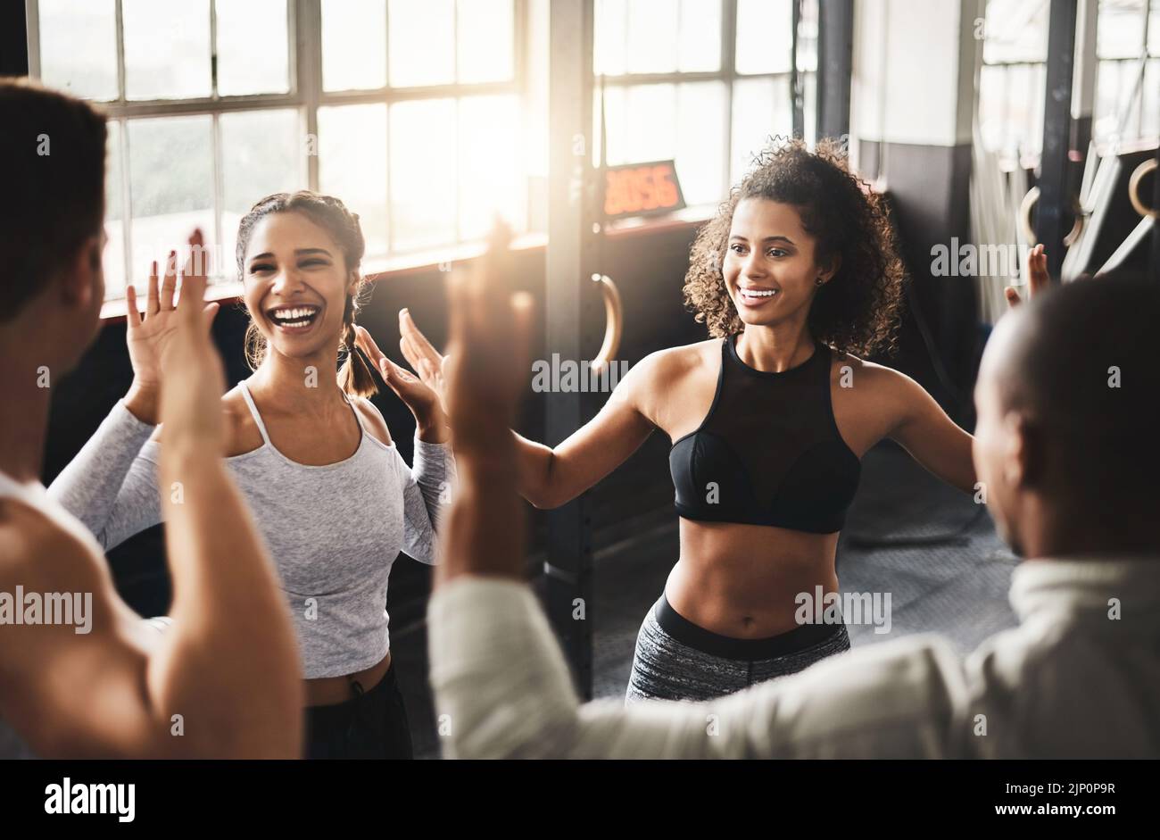 Fitness made fun. a group of young people working out together in a gym ...