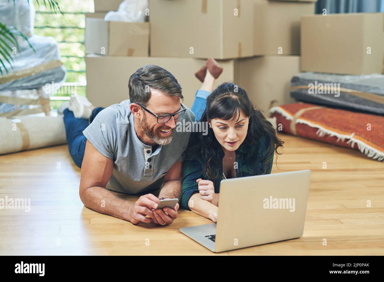 An easy moving day is a planned out one. a husband and wife using a ...