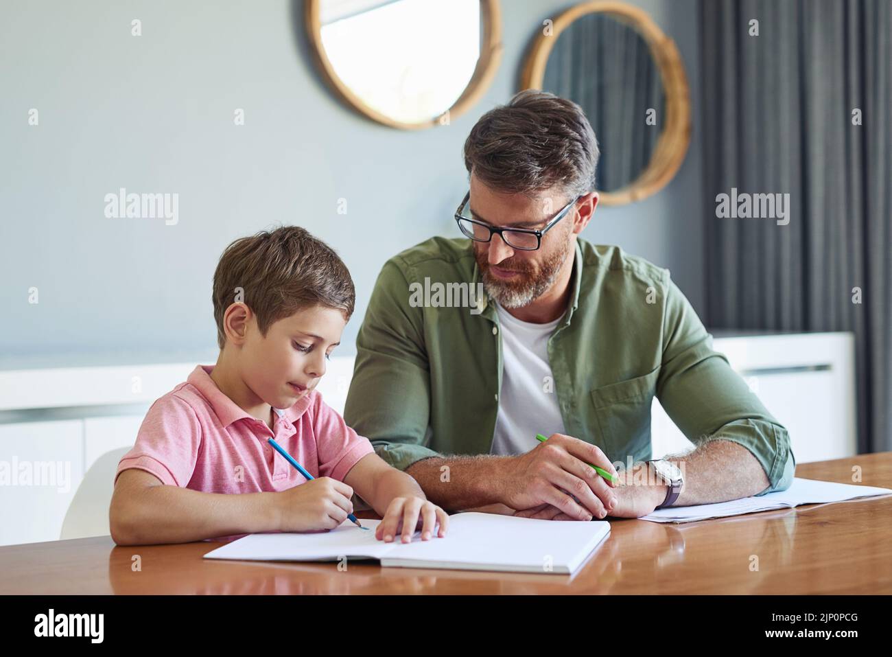 Dads there to give him all the guidance he needs. a father helping his ...