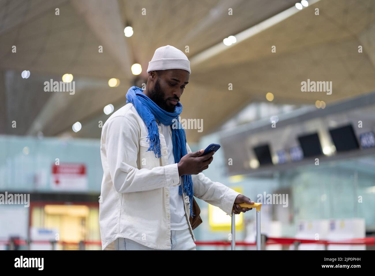 African American man passenger looking at mobile boarding pass on ...