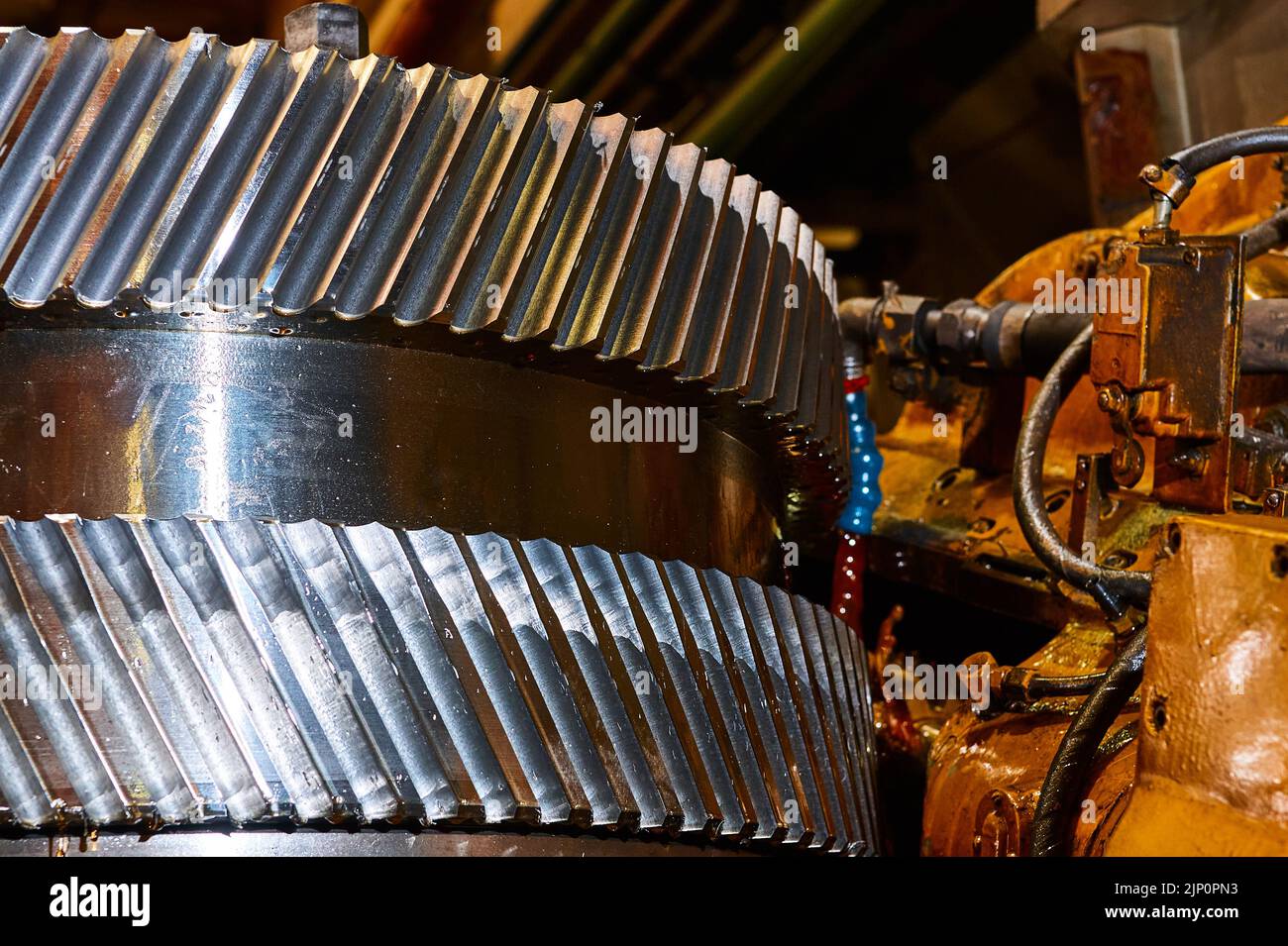 Cogwheels of spiral gear drive in production workshop Stock Photo - Alamy