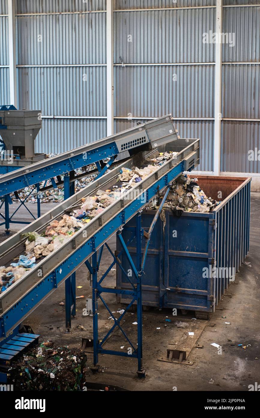 Large container and belt conveyors transporting garbage Stock Photo - Alamy