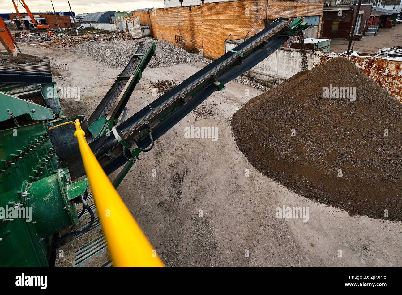Mobile crushing and sorting complex works among soil piles Stock Photo ...